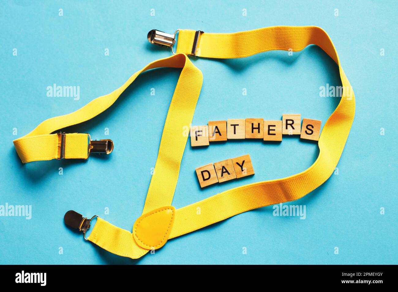 happy father's day lettering made by wooden cubes on a blue background ...