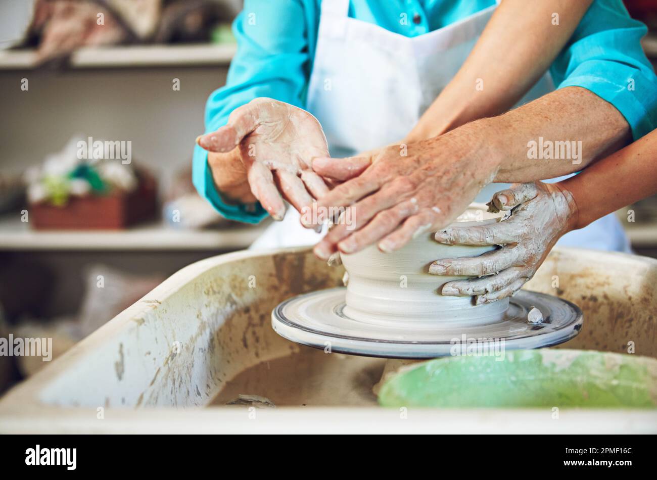 They have a hands-on marriage. a senior couple making a ceramic pot ...