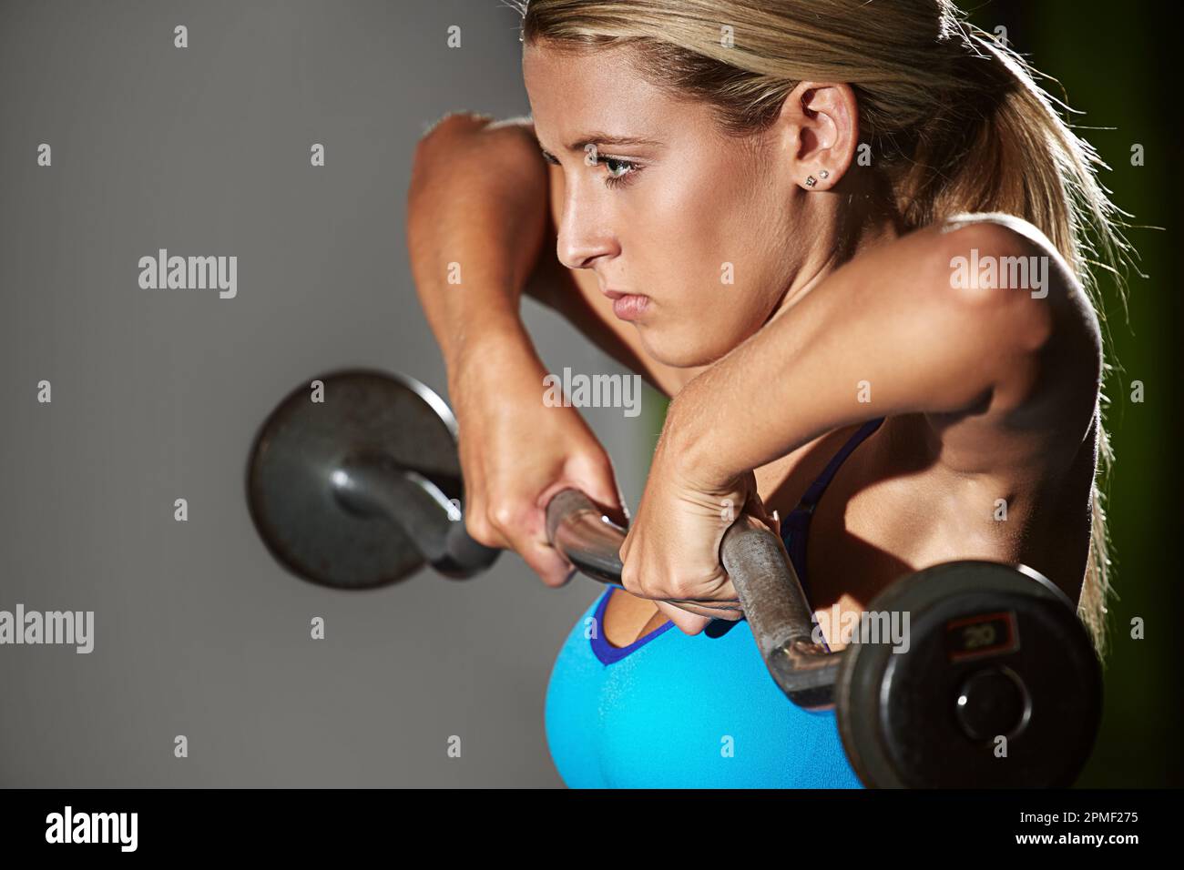 I dont use machines, I am one. a young woman working out with weights ...