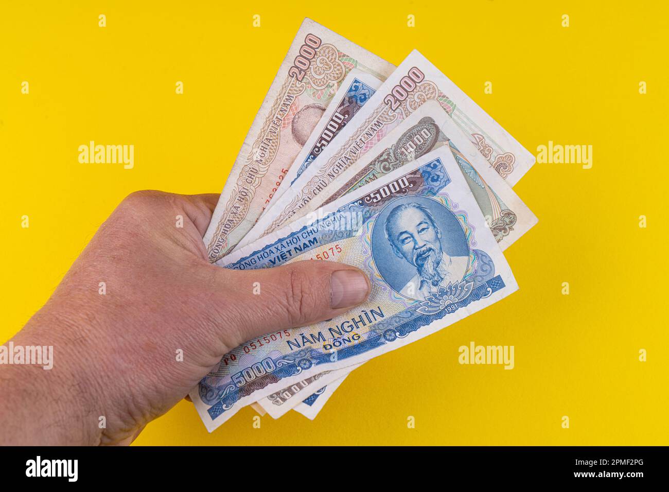 some Vietnamese Dong banknotes on a yellow surface Stock Photo - Alamy