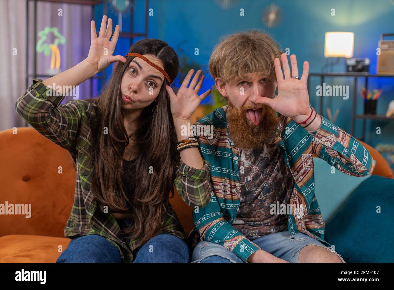 Family marriage hippie couple man woman making playful silly facial expressions and grimacing ...