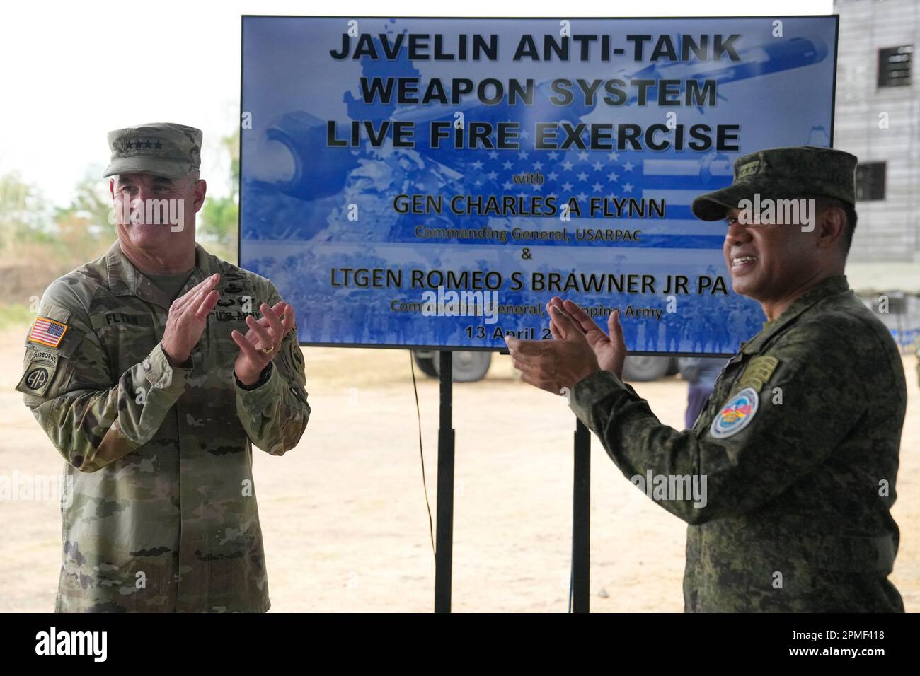 U.S. Gen. Charles Flynn, left, Commanding General USARPAC, claps with ...