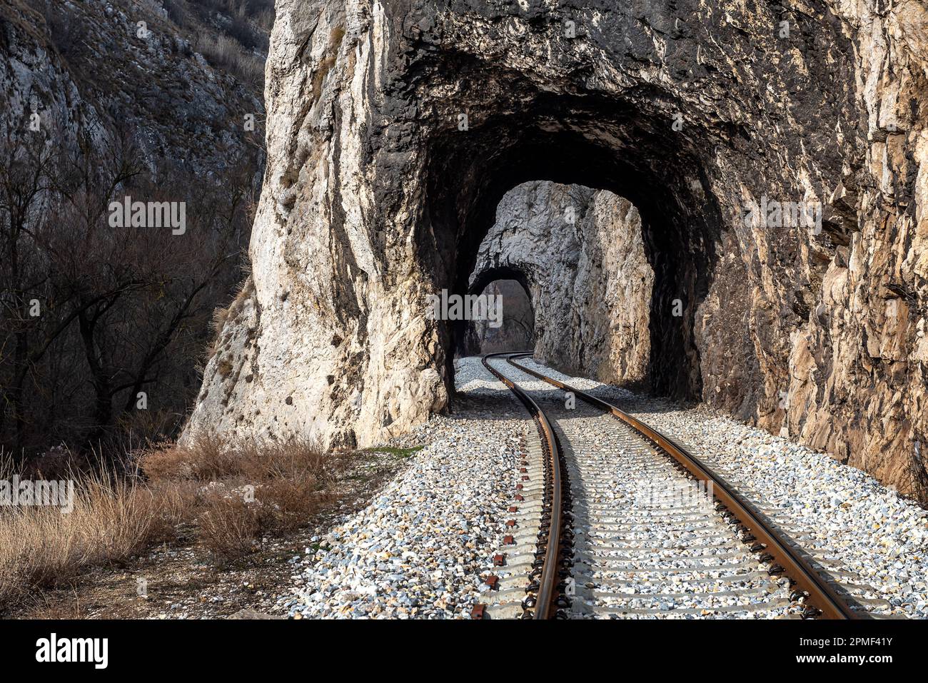 Old railway passing through short tunnels in picturesque rural scenery ...