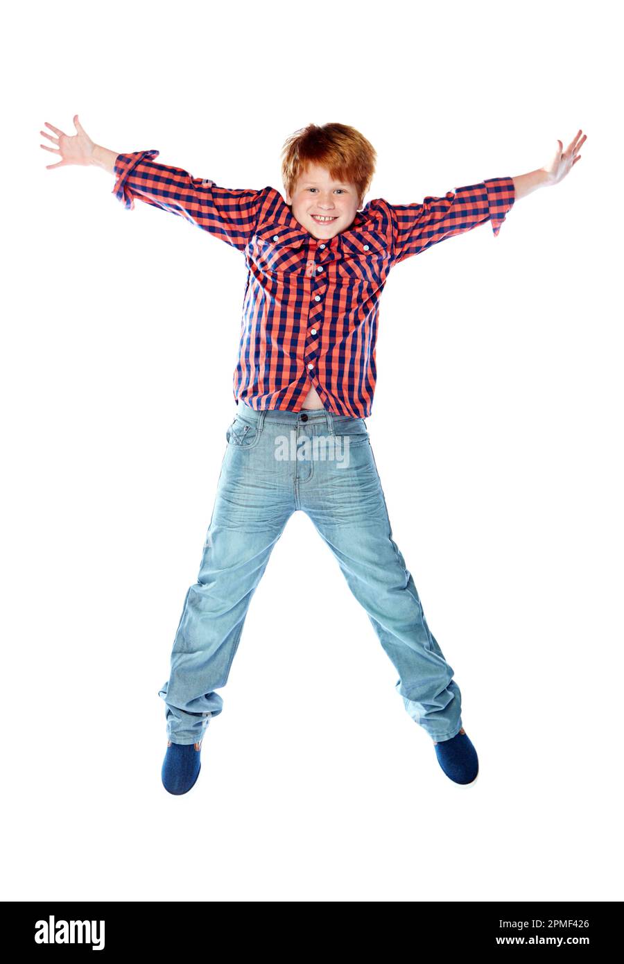 Bouncing boys. Studio shot of a young boy jumping for joy against a ...