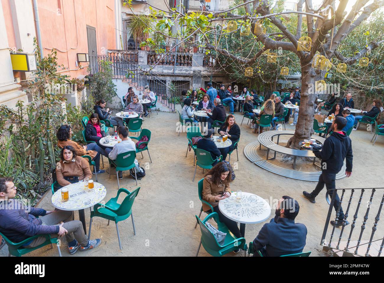Barcelona, Spain - March 13, 2023: People sitting outside at cafe in ...