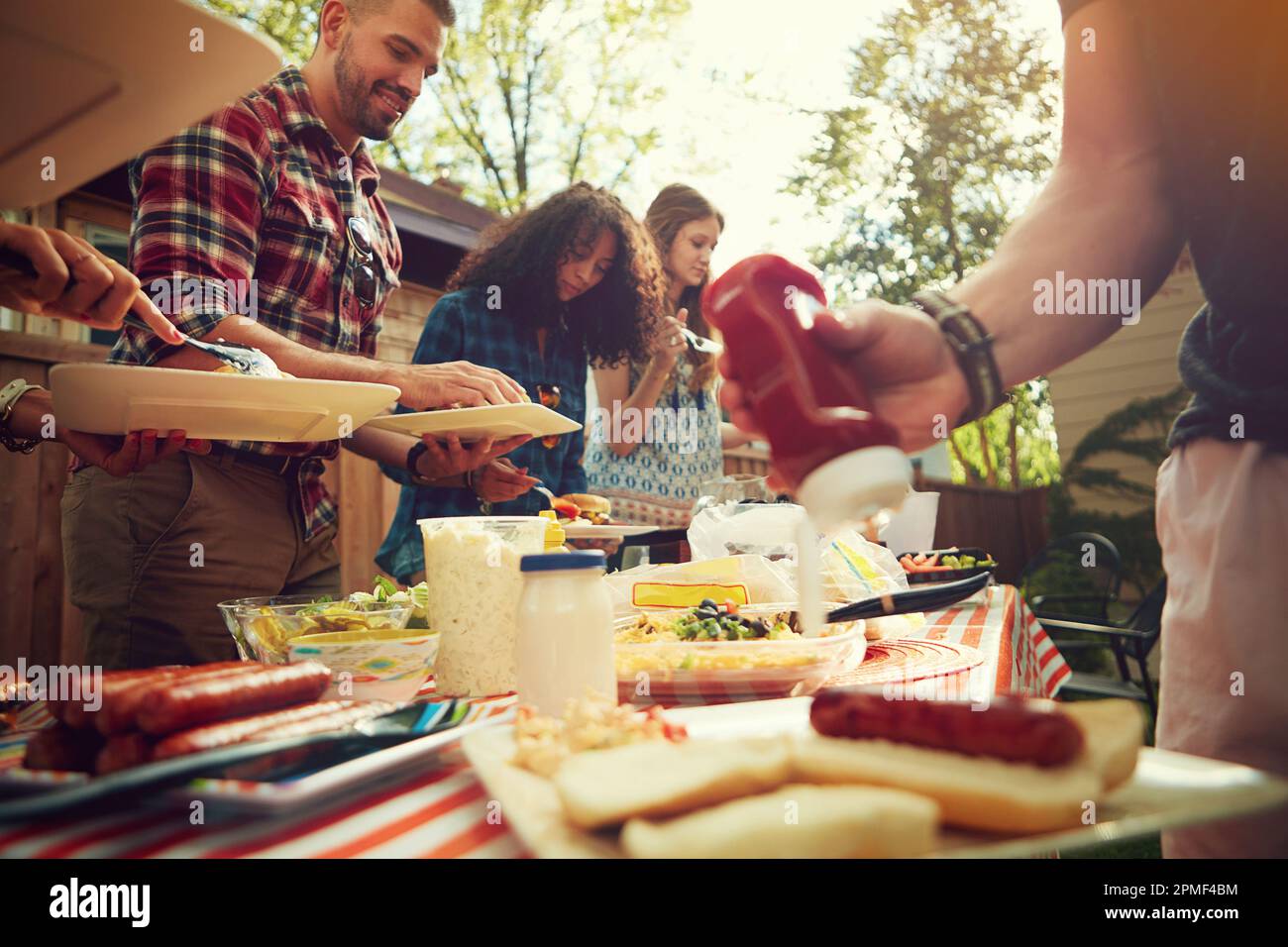 The first taste of summer. a group of friends having lunch in their ...