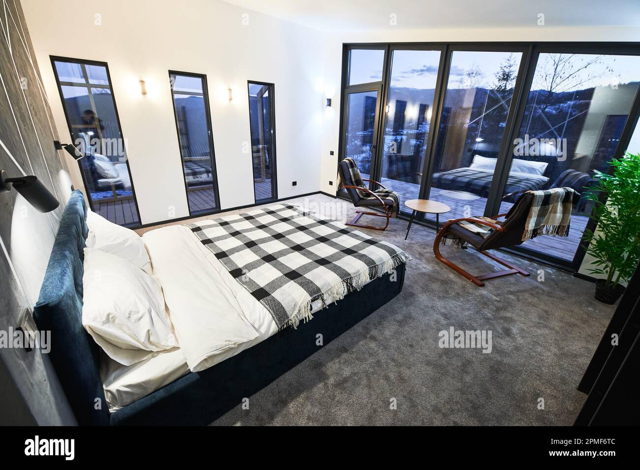 Cozy modern furnished chalet room with reflection in large panoramic ...