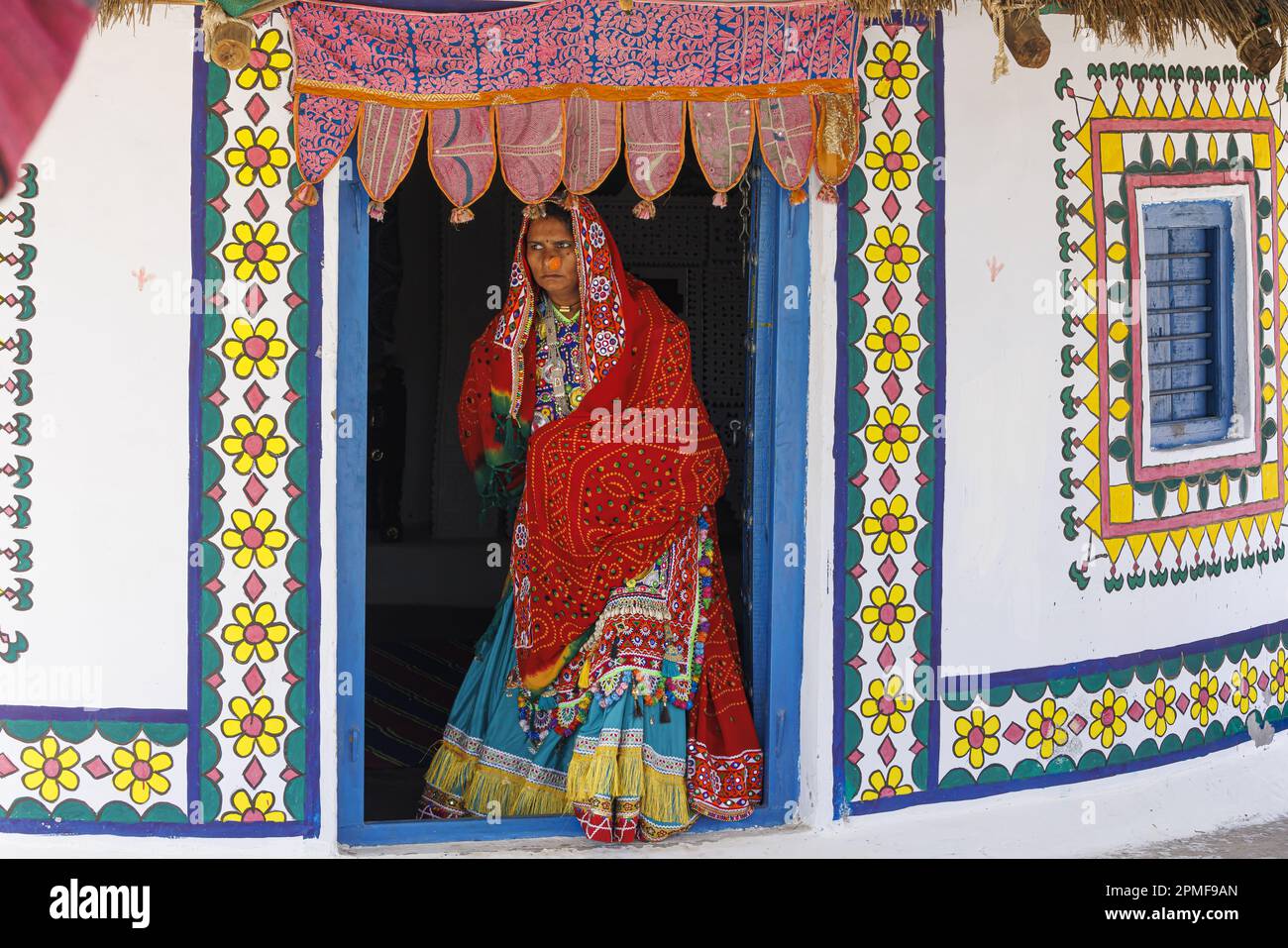 India, Gujarat, Ludiya, Meghwal or Harijan woman at the door of her ...