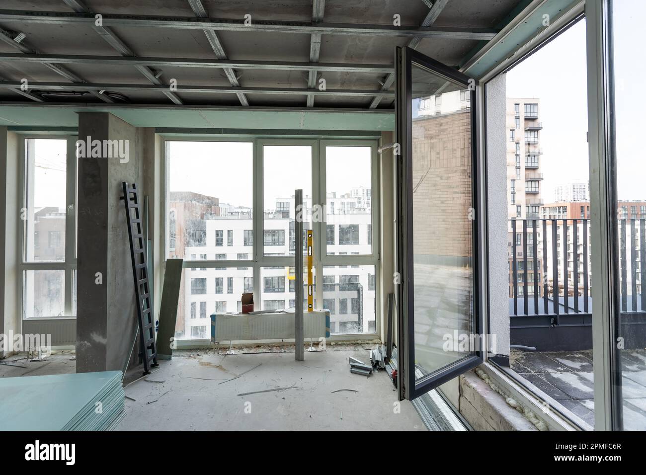 Construction worker assemble a suspended ceiling with drywall and ...