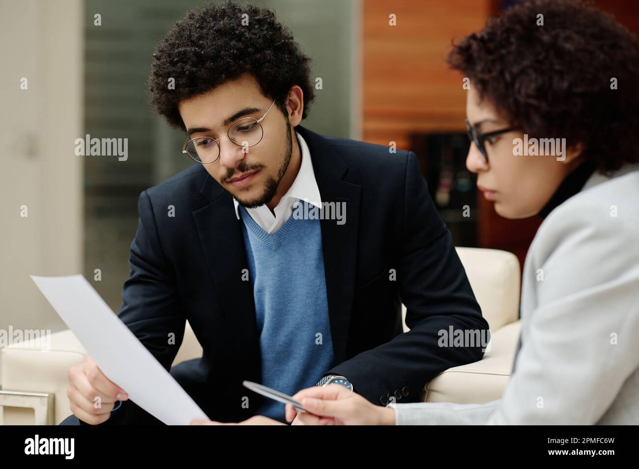 Business partners discussing contract together during business meeting ...