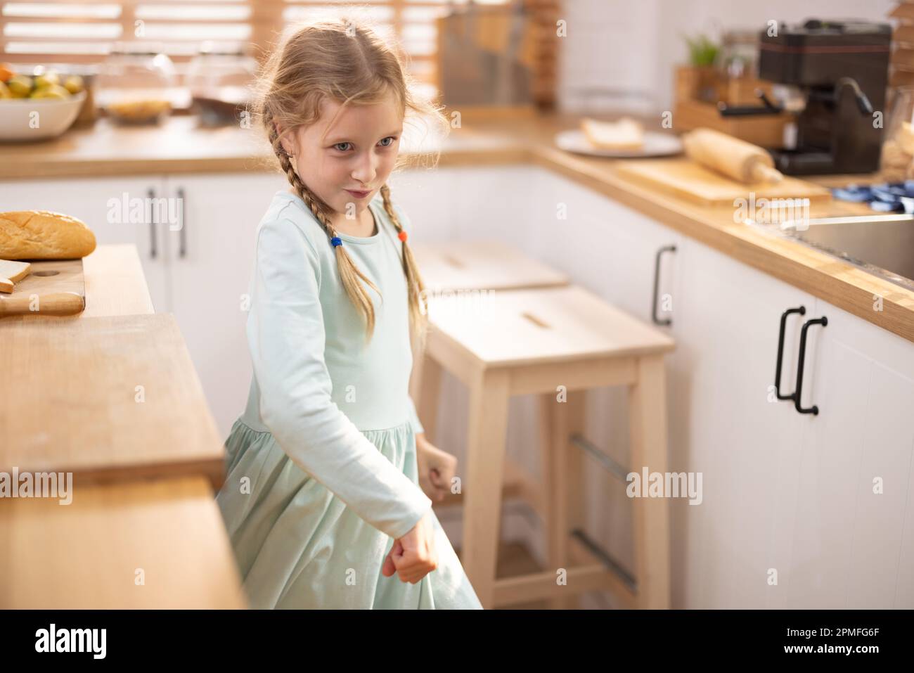 An enthusiastic girl makes a funny, quirky and grimacing face. Innocent ...