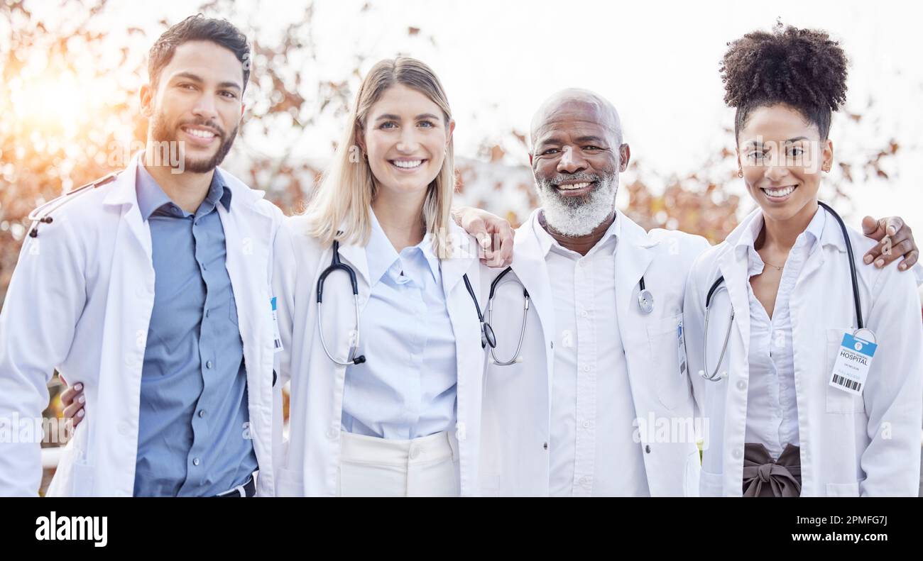 Doctors, hug together and group portrait for motivation, success or ...