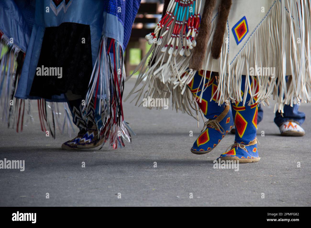 Native American people wearing a traditional blue costume and boots are ...