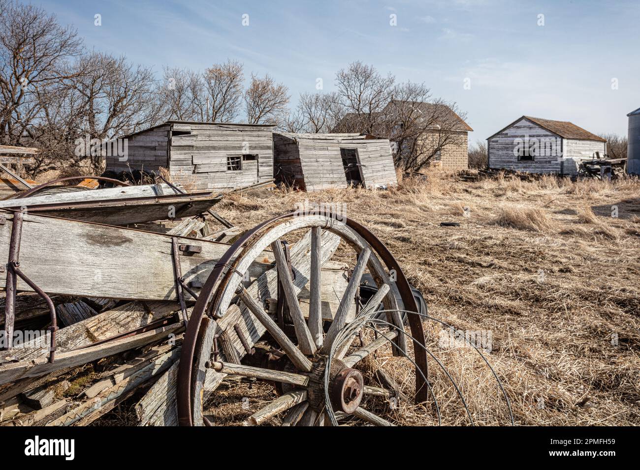 A weathered and aged wheelbarrow in a rural landscape with multiple ...