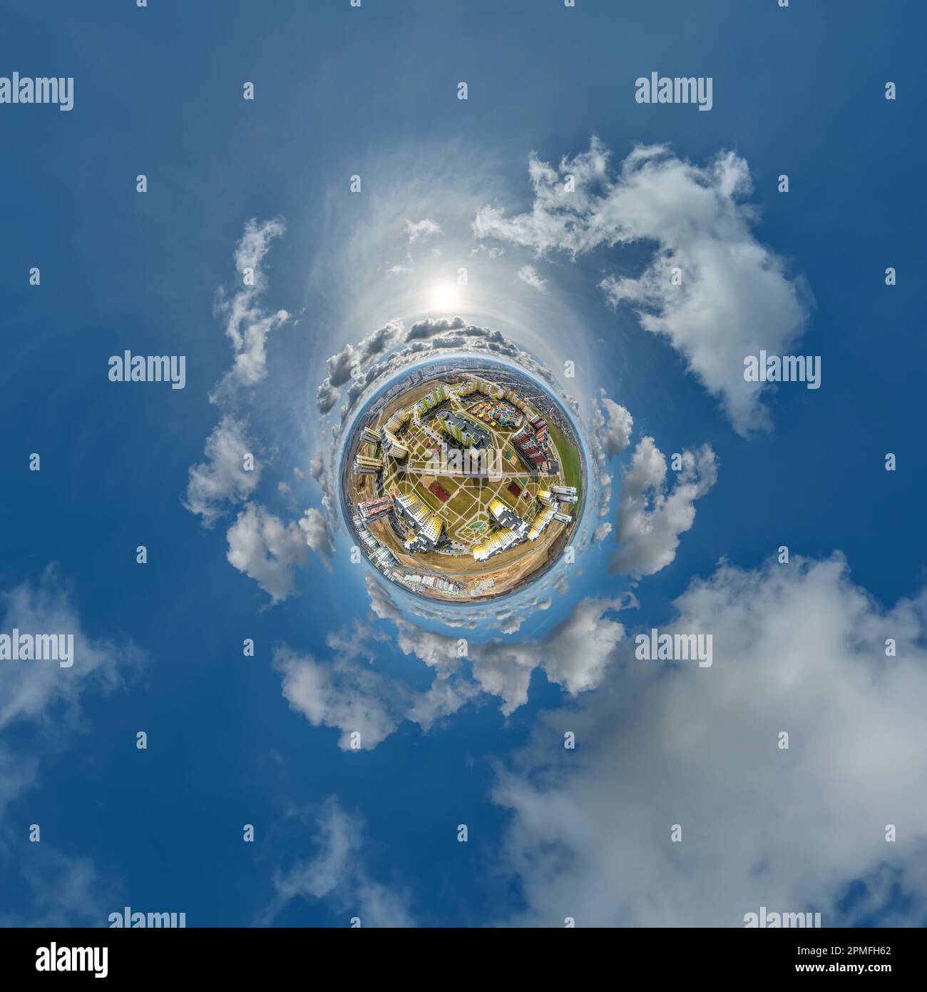 tiny planet in sky with clouds overlooking skyscrapers in new modern ...