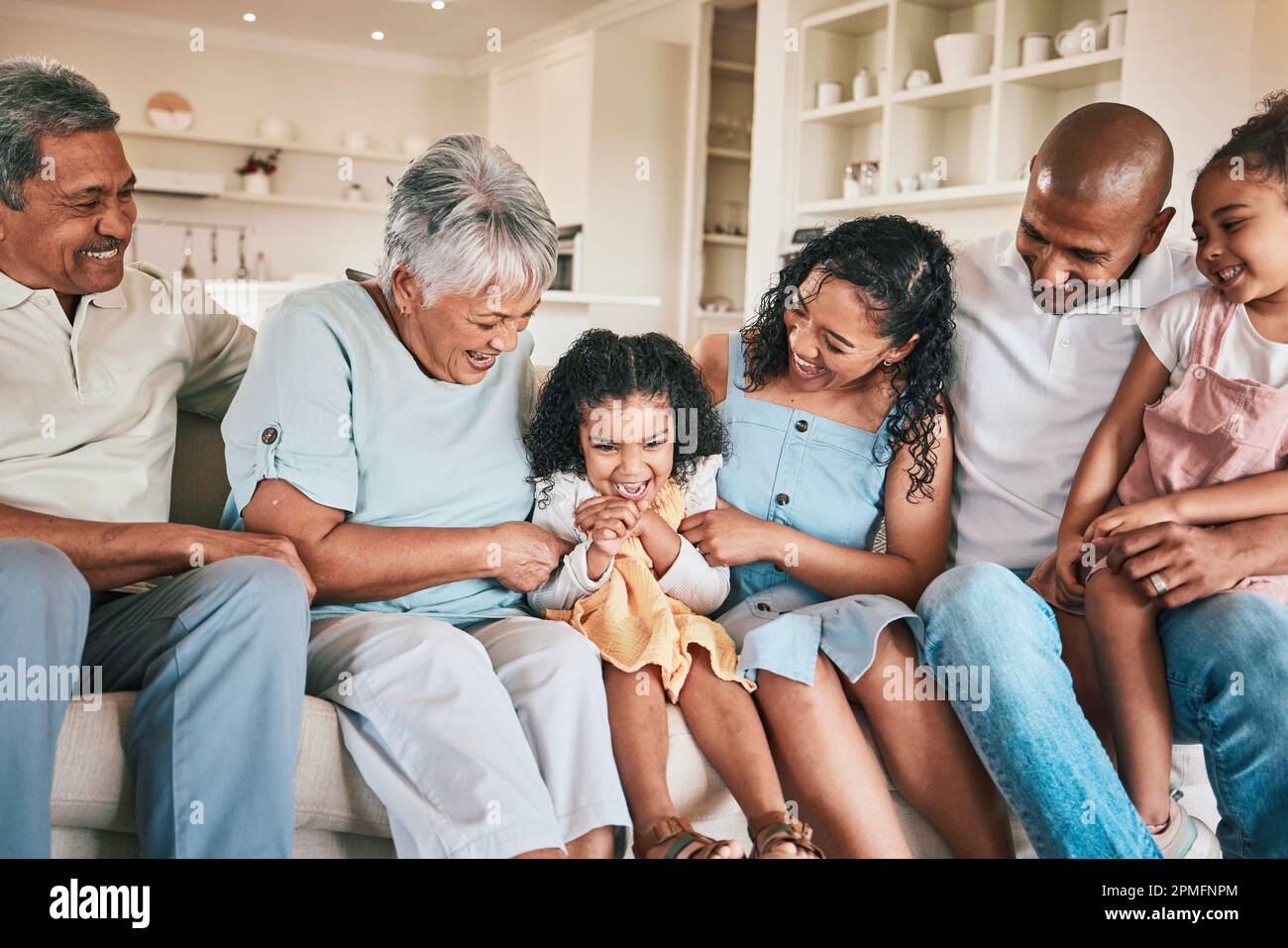 Family, tickle and child with happy people in relax home with love and ...