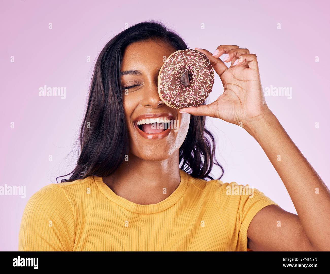 Donut, laughing and cover with woman in studio for diet, snack and ...
