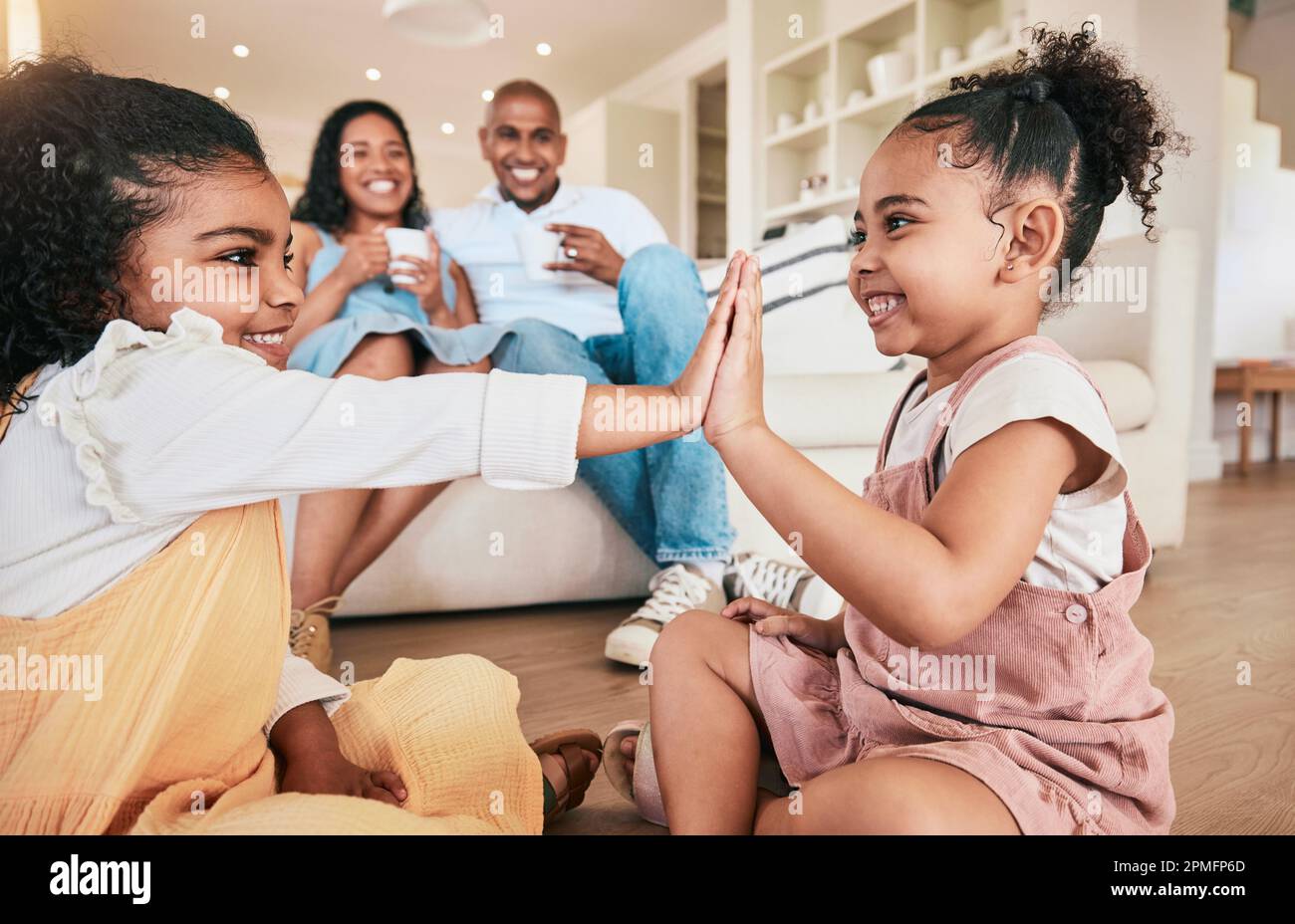 Family, high five and children playing, smile and having fun in a ...