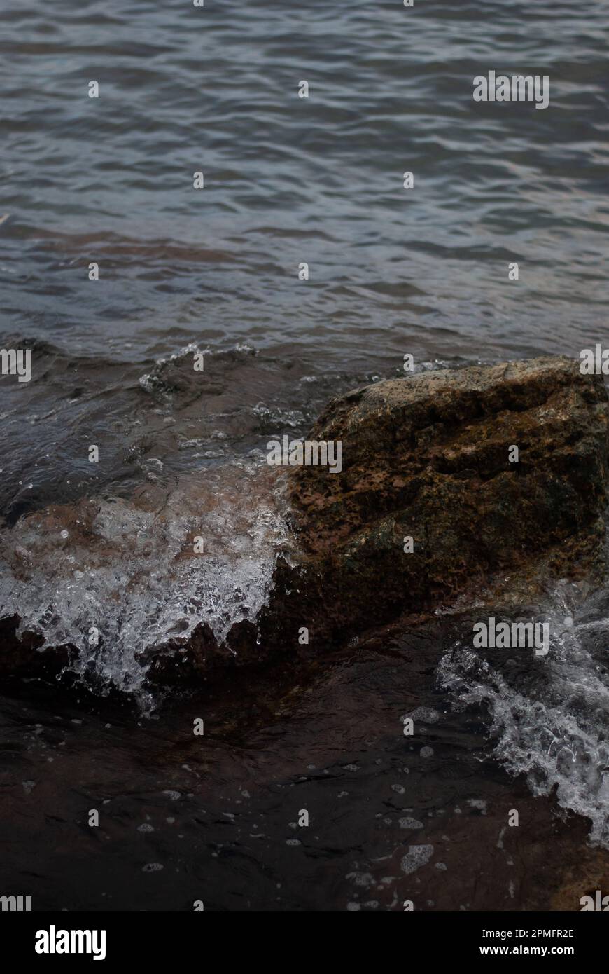 Stones with foam and waves in the sea Stock Photo - Alamy