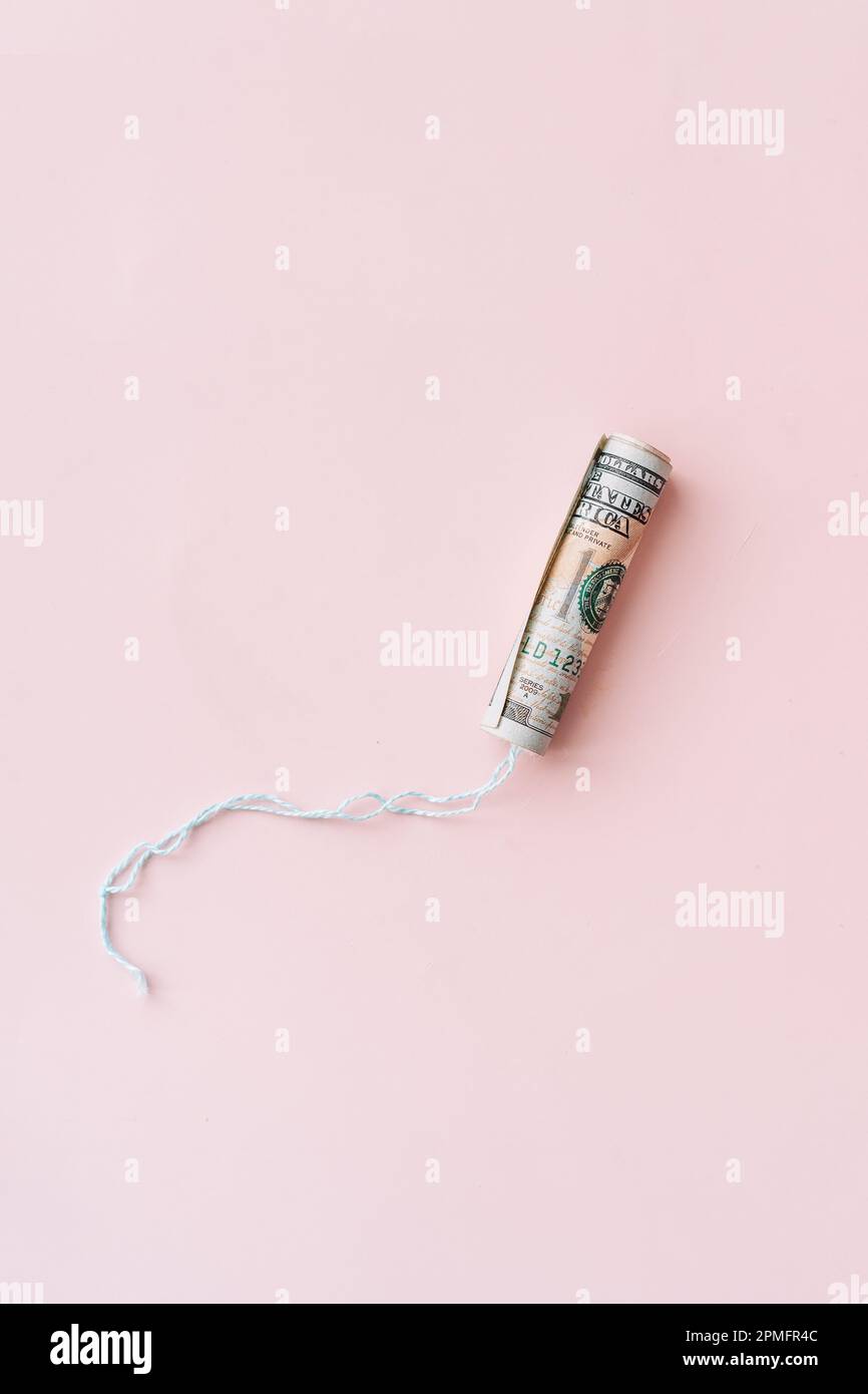 Tampon wrapped in hundred dollar bill on pink background Stock Photo ...