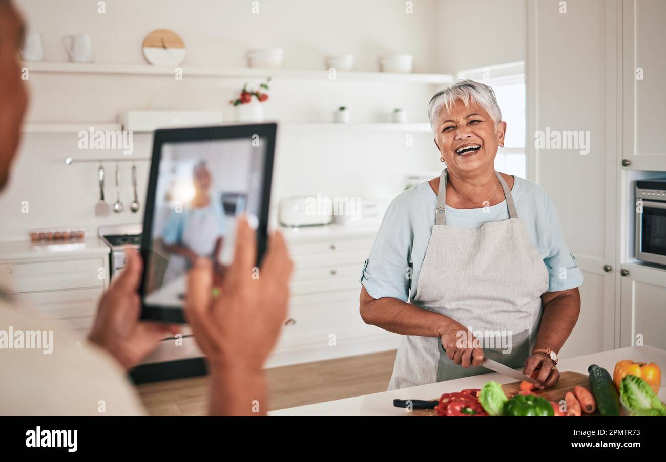 Cooking food, elderly couple and tablet photo of senior woman, wife or ...