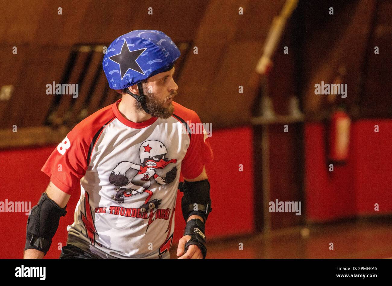Male roller derby skater wearing a star helmet cover which makes him ...