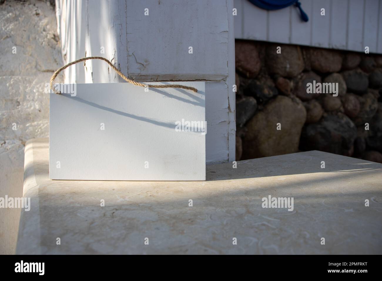 white hanging picture sign with a mainly white background with empty ...