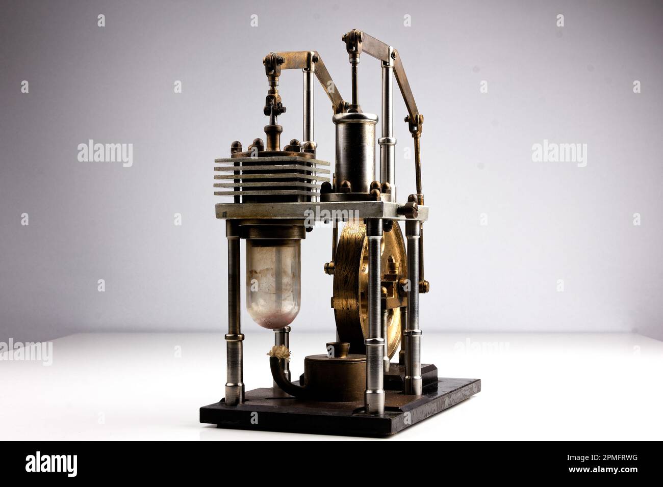 close up of a stirling engine construction with white table and white ...