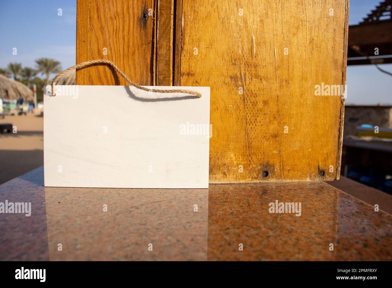 wood background and white hanging picture sign with empty free space ...