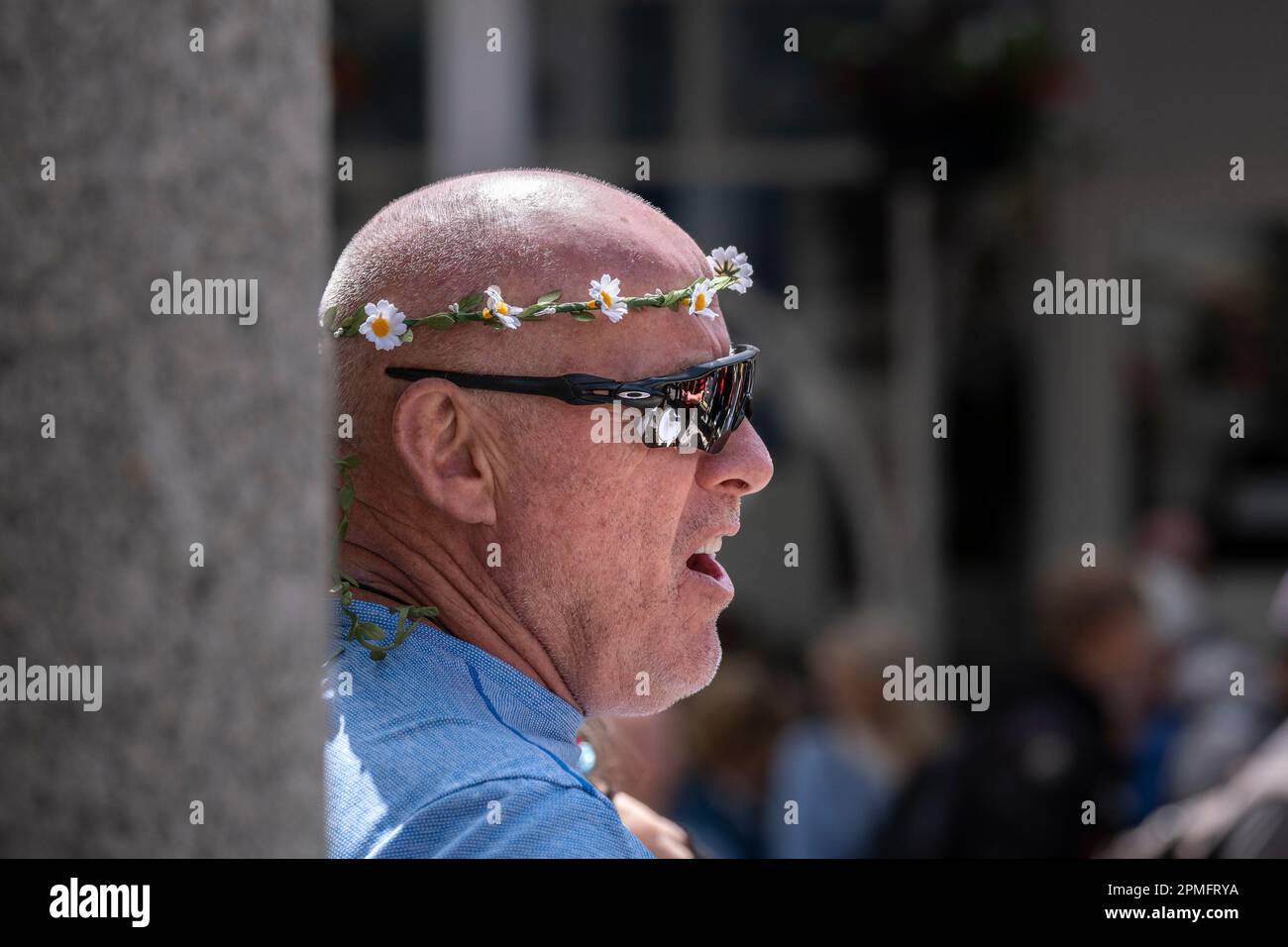 A bald man with a garland of flowers around his head Stock Photo - Alamy