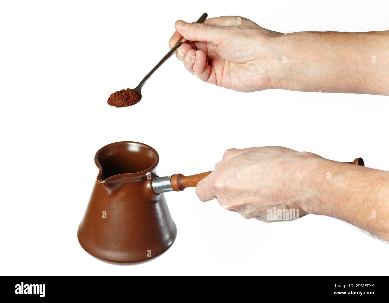 Men's hand holding spoon with coffee powder isolated white background ...