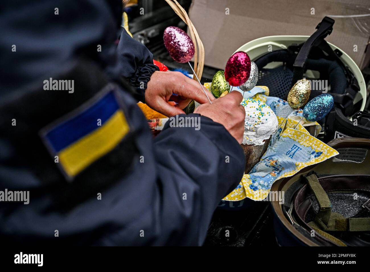 ORIKHIV, UKRAINE - APRIL 12, 2023 - A rescuer decorates a paska ...