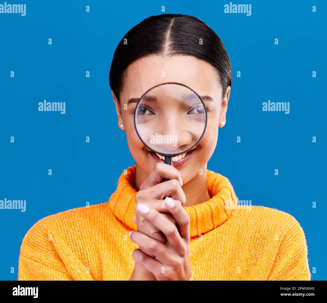 Woman, magnifying glass and smile in studio portrait with funny face ...