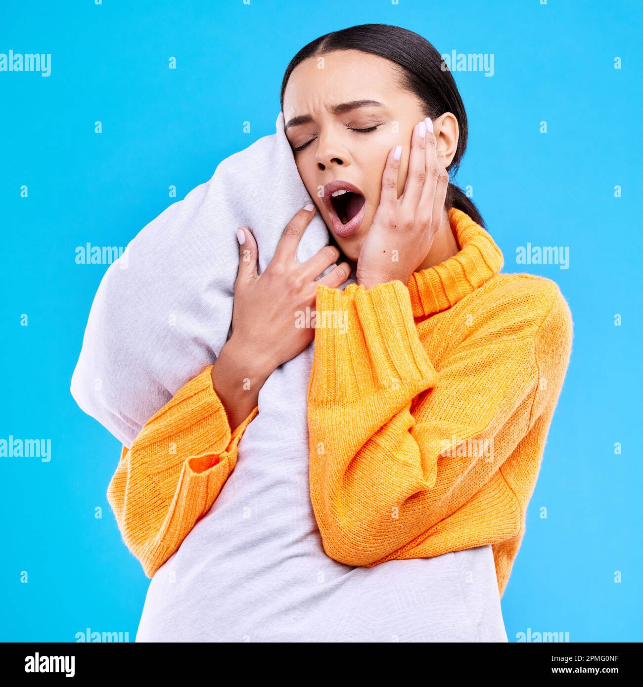 Tired woman, pillow and yawn in studio with exhausted face, and ready ...