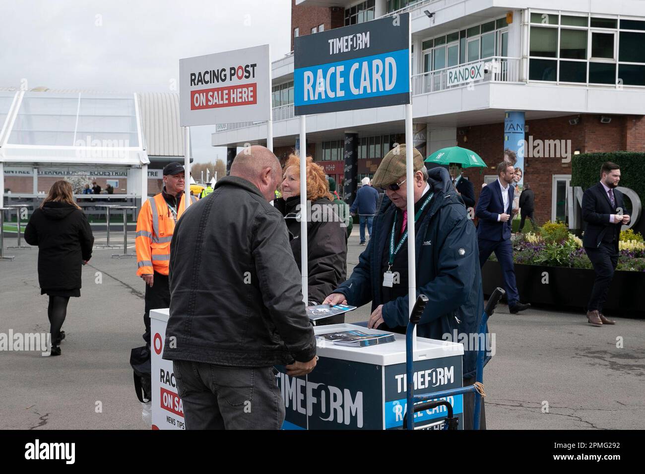 Punters buying a race card ahead of the Randox Grand National festival ...