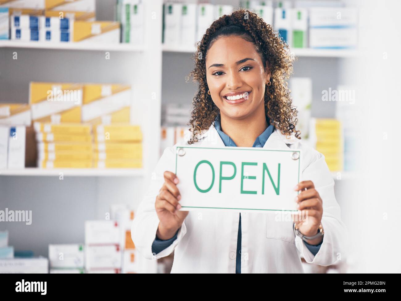 Open sign, medical board and woman portrait in a pharmacy with a ...