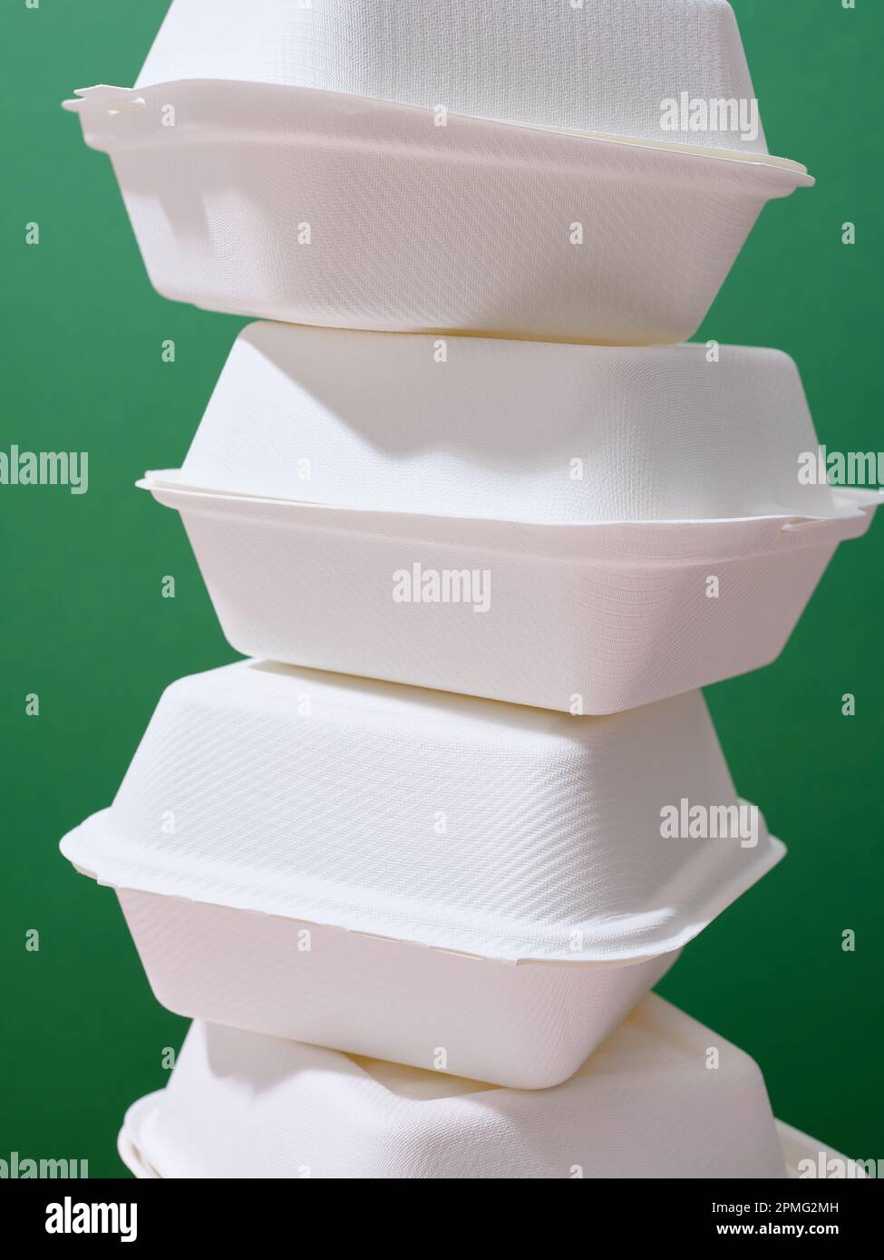 Ecological food delivery packaging. Burger takeaway boxes on green and ...