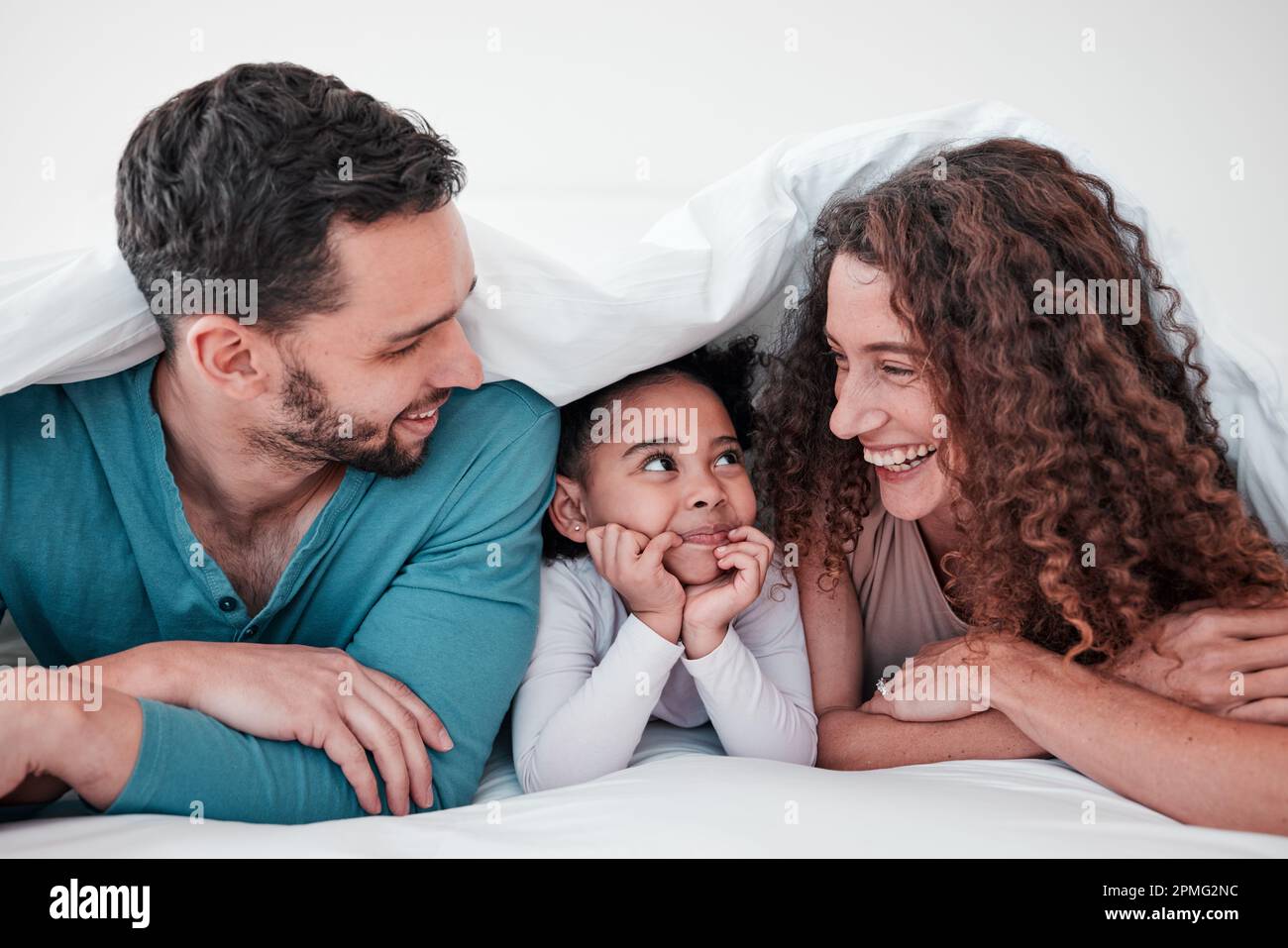 Family, parents are happy with child in bed and relax under blanket in ...