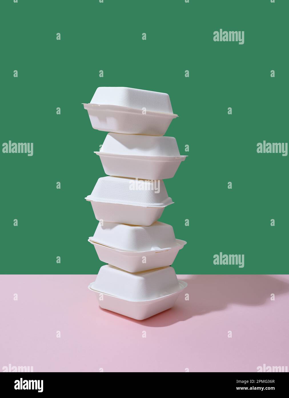 Ecological food delivery packaging. Burger takeaway boxes on green and ...