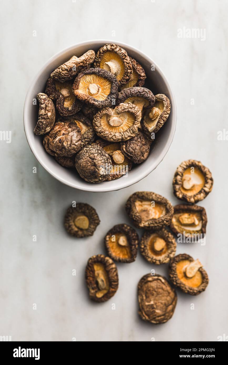 Dried shiitake mushrooms in bowl on the kitchen table. Top view Stock ...