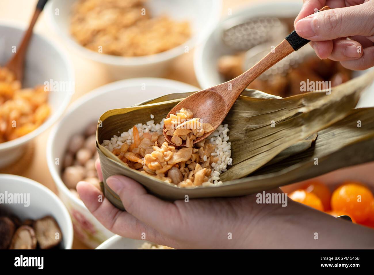 Making zongzi food - preparing and wrapping Chinese rice dumpling at ...