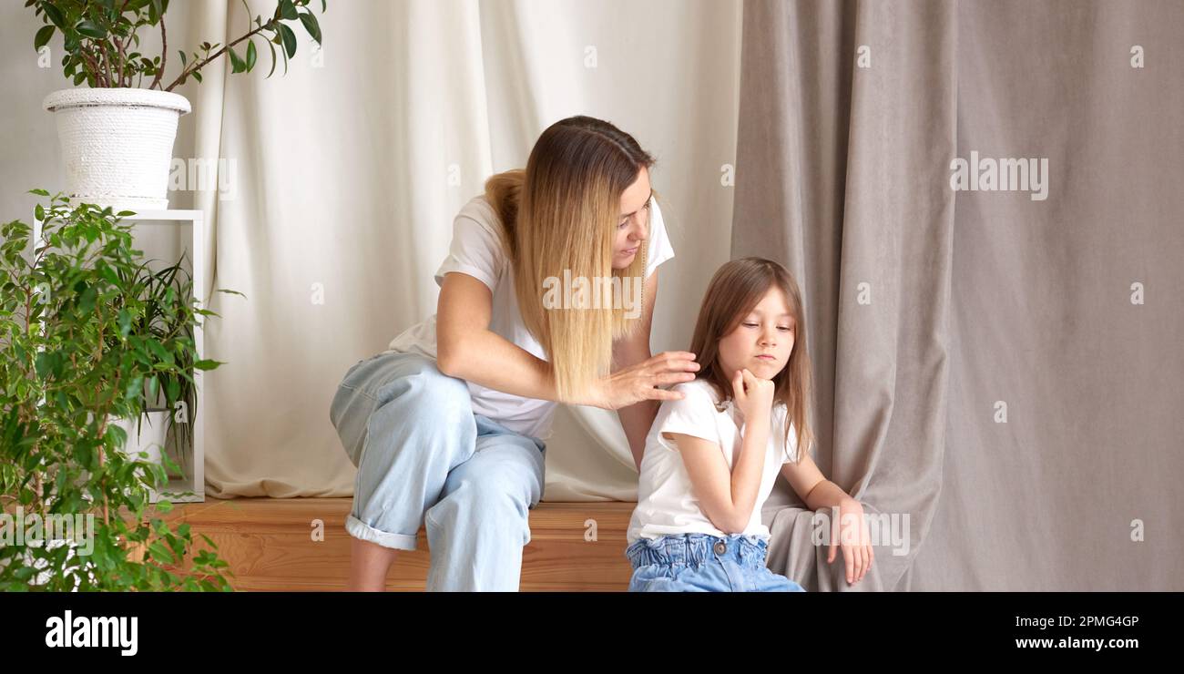 sad child girl and loving caring mother comforting offended afraid daughter, showing love and ...