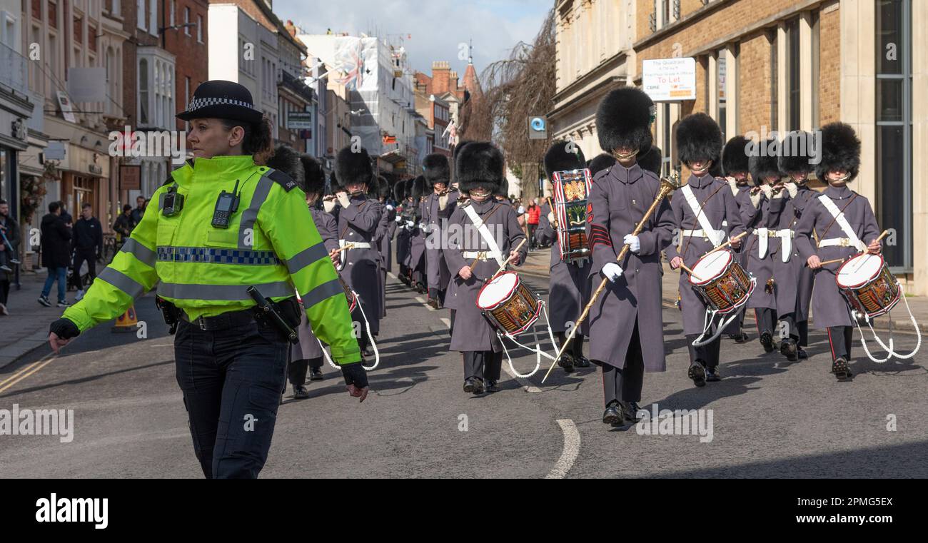 Windsor, Berkshire, England, UK. Police officer escorting military band ...