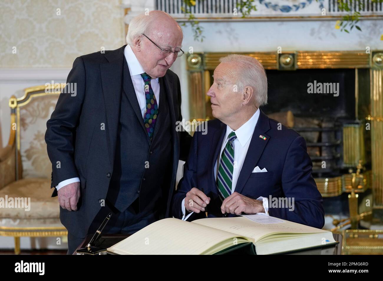 President Joe Biden signs the guest book as he meets with Irish ...