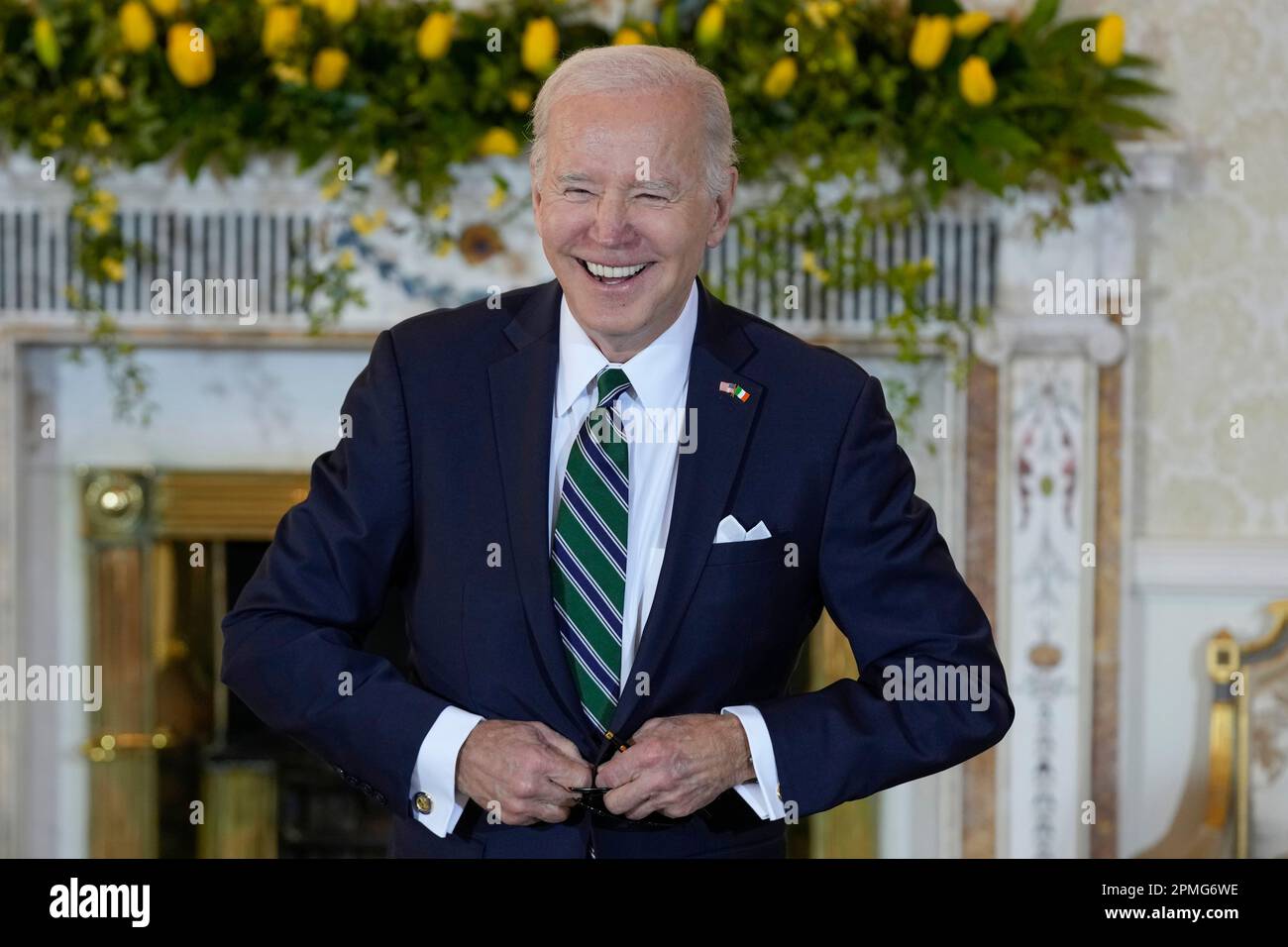 President Joe Biden smiles after signing the guest book as he meets ...