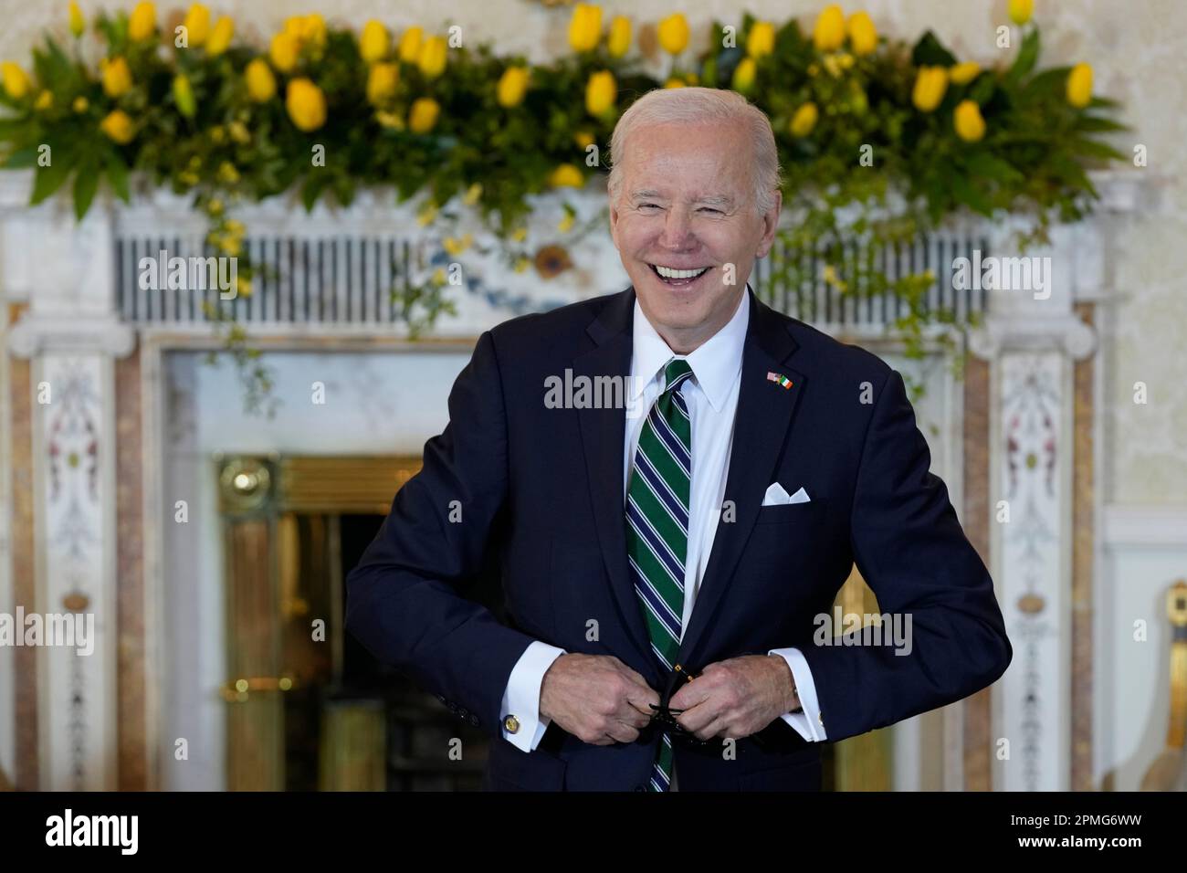 President Joe Biden smiles after signing the guest book as he meets ...