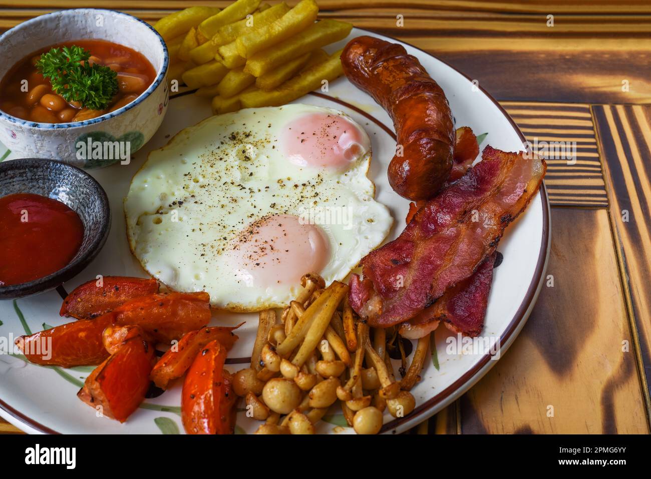 Healthy english breakfast with fried eggs, bacon, french fries, bean ...