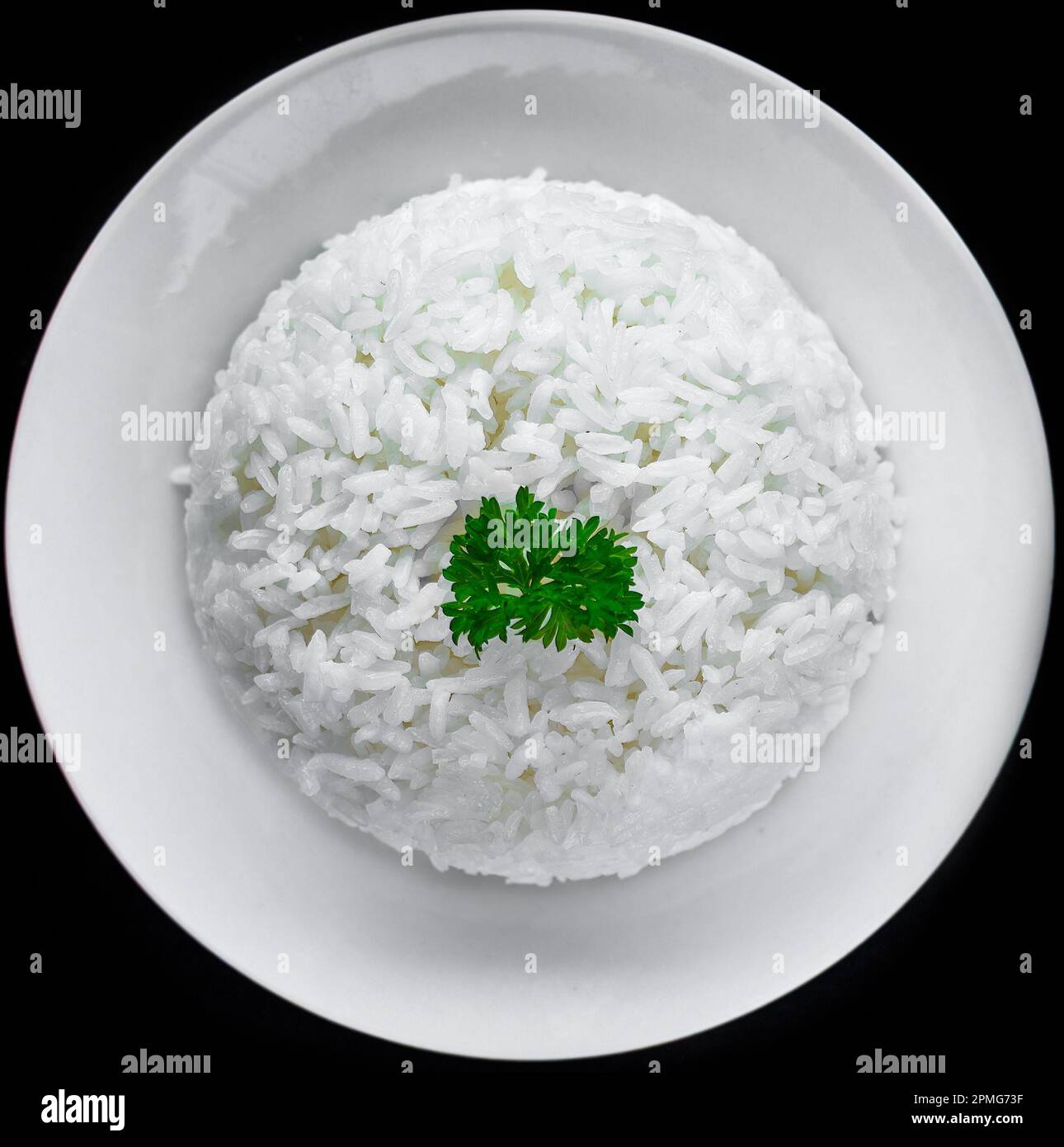 Plate with white rice, serving for Vietnamese dishes on black ...