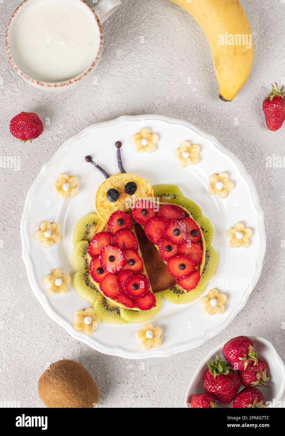 Funny pancakes in the form ladybug with strawberry, banana and kiwi for ...