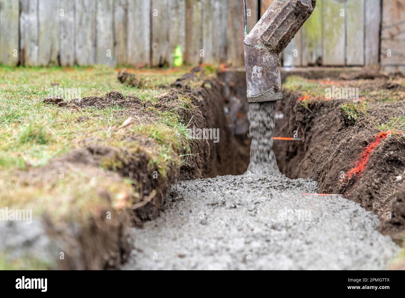 concreting from the pipe of the cement mixing car Stock Photo - Alamy